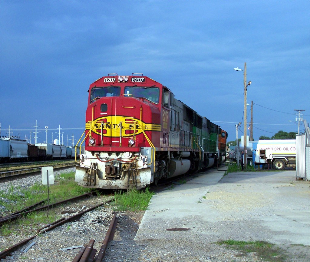 BNSF 8207 and pals are resting on the ready tracks drinking fuel